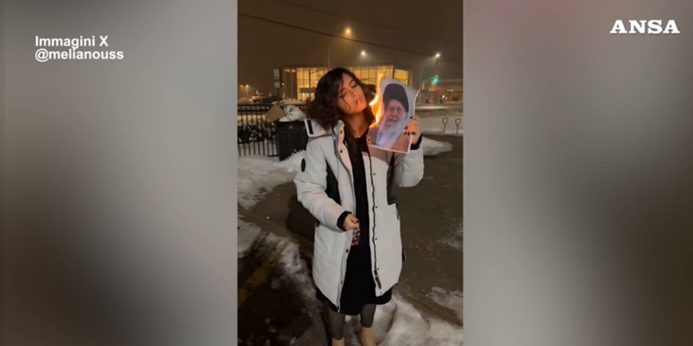 Cigarettes lit with the burning photo of Khamenei, the protest of ...